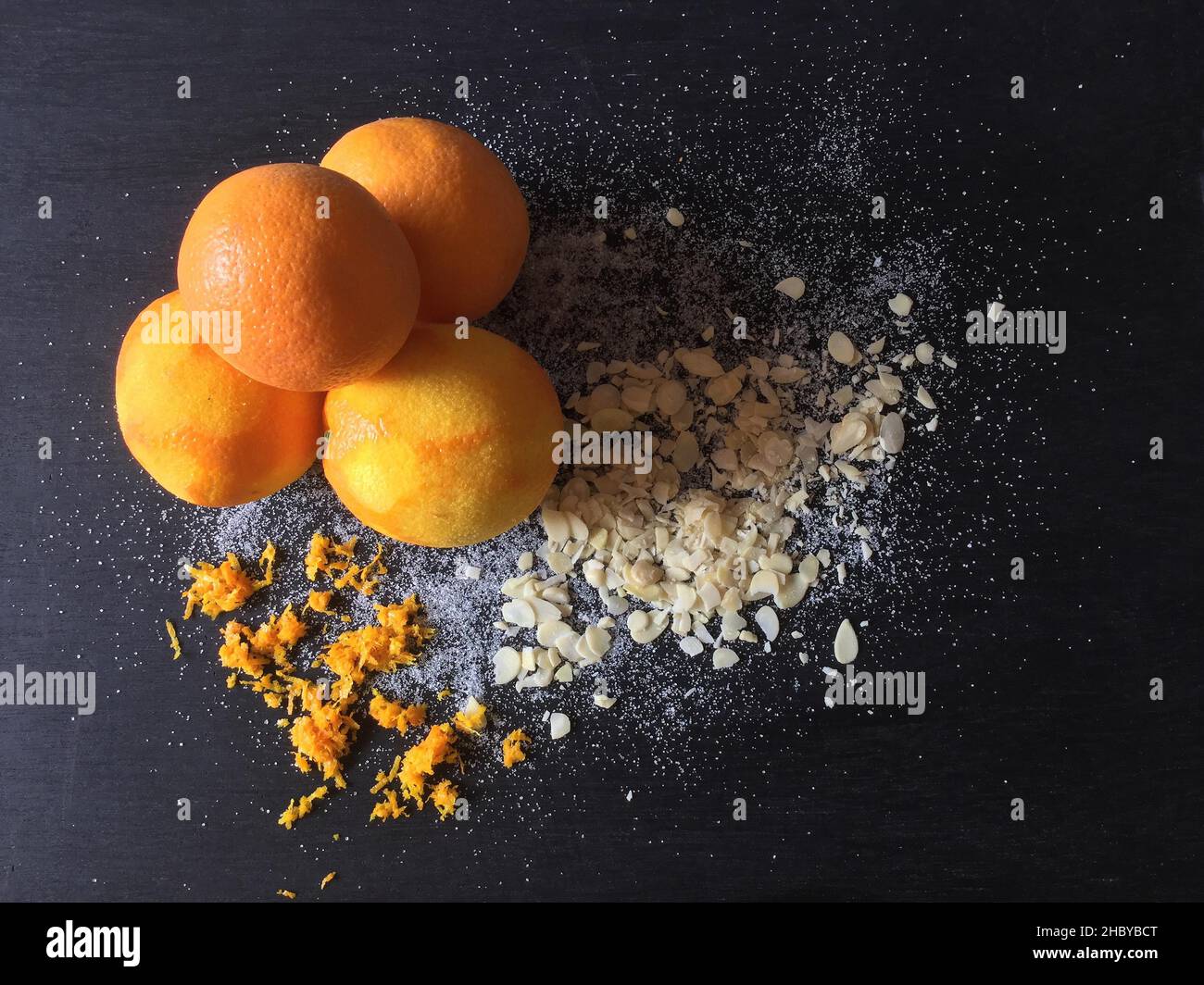 Oranges with abrasion and almond slivers on slate board, top view, from ...