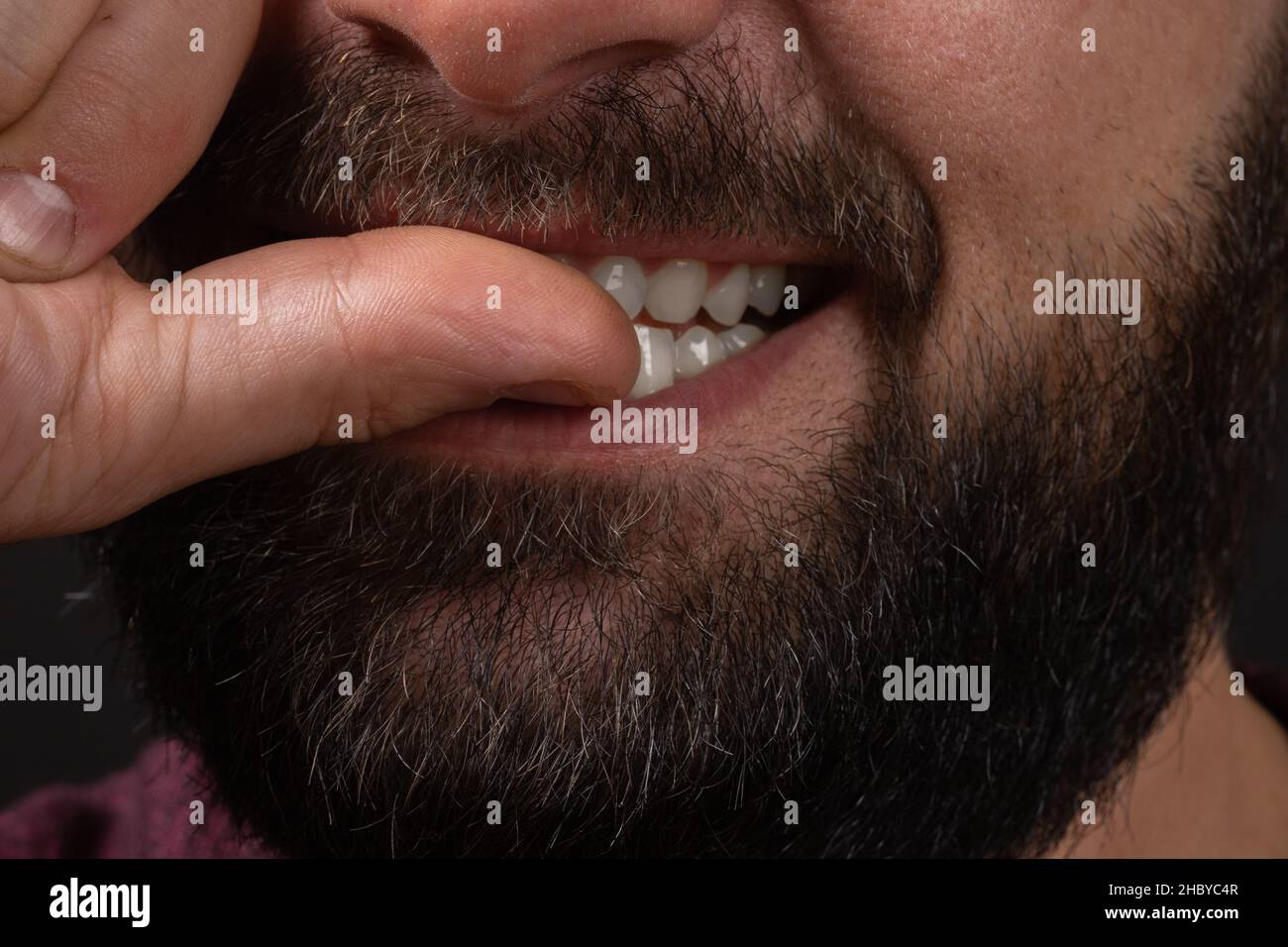 male lips with untrimmed beard at closeup. Close up of male part of ...