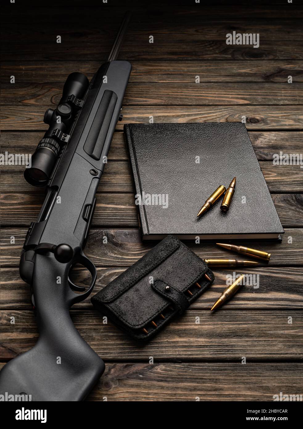 A modern bolt-action scout rifle with a telescopic sight. Weapon on a ...