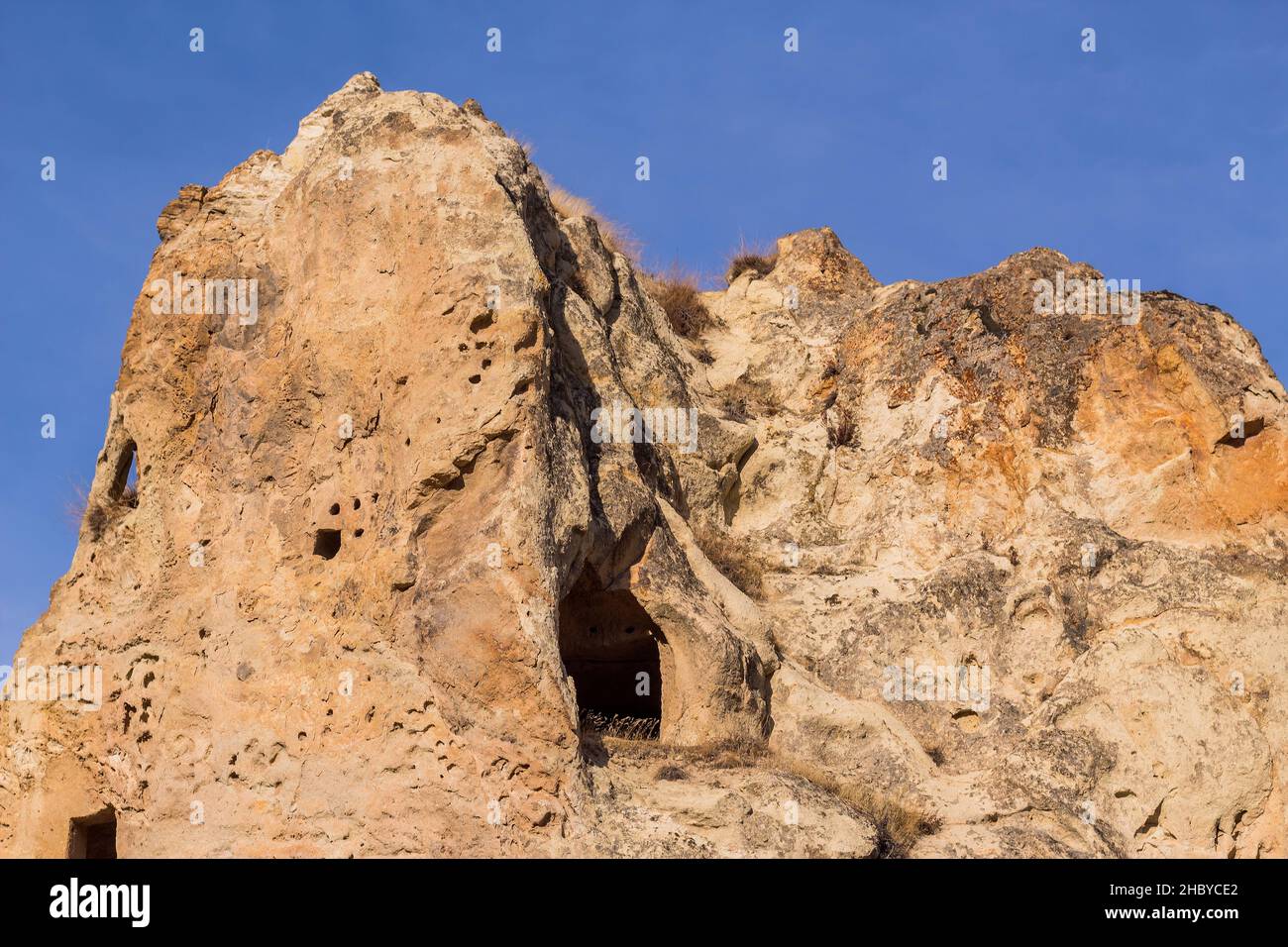 View of house carved in cave. Ruins of an ancient cave house ...