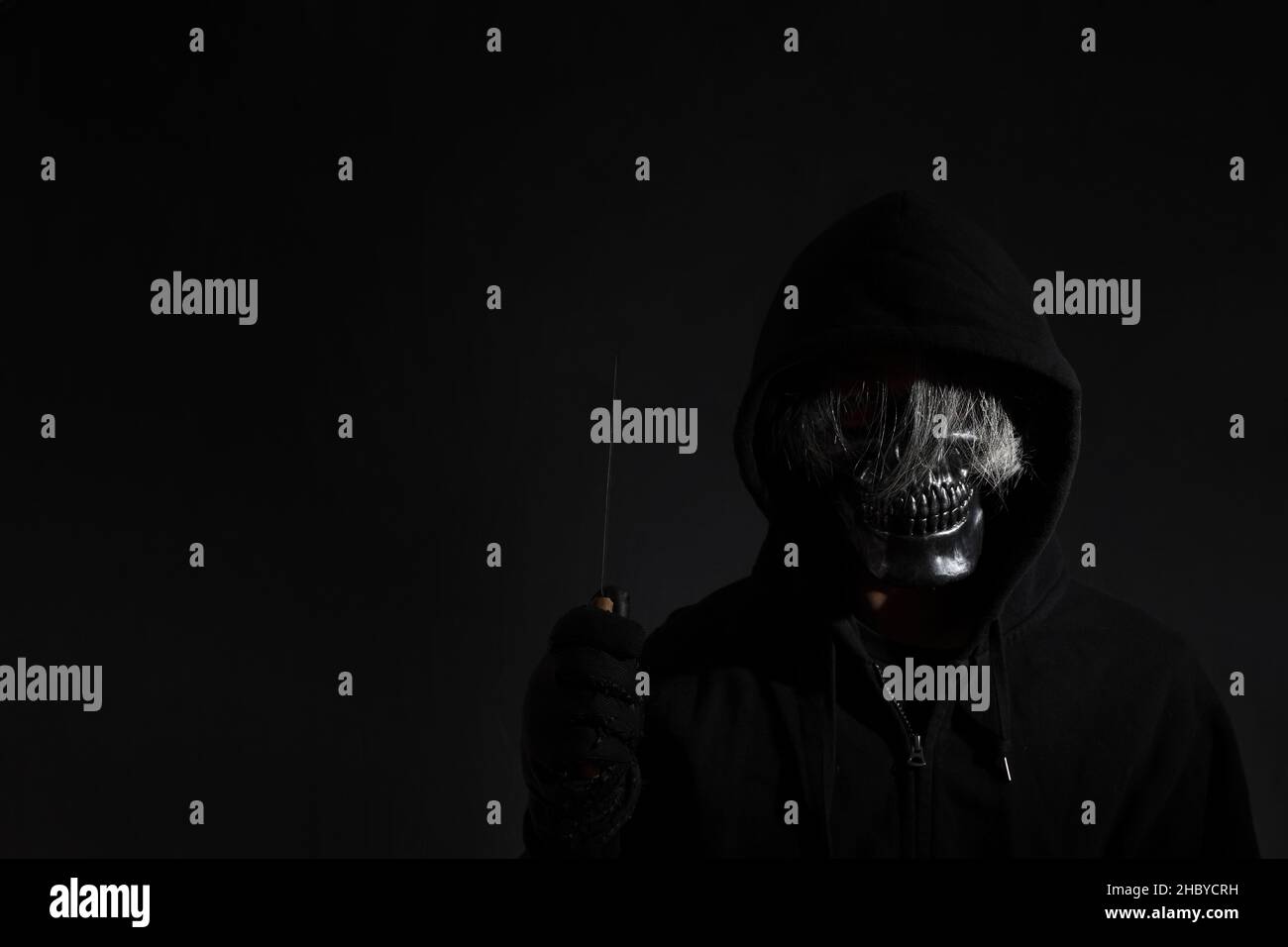 The horror man with skull mask standing in the dark Stock Photo - Alamy