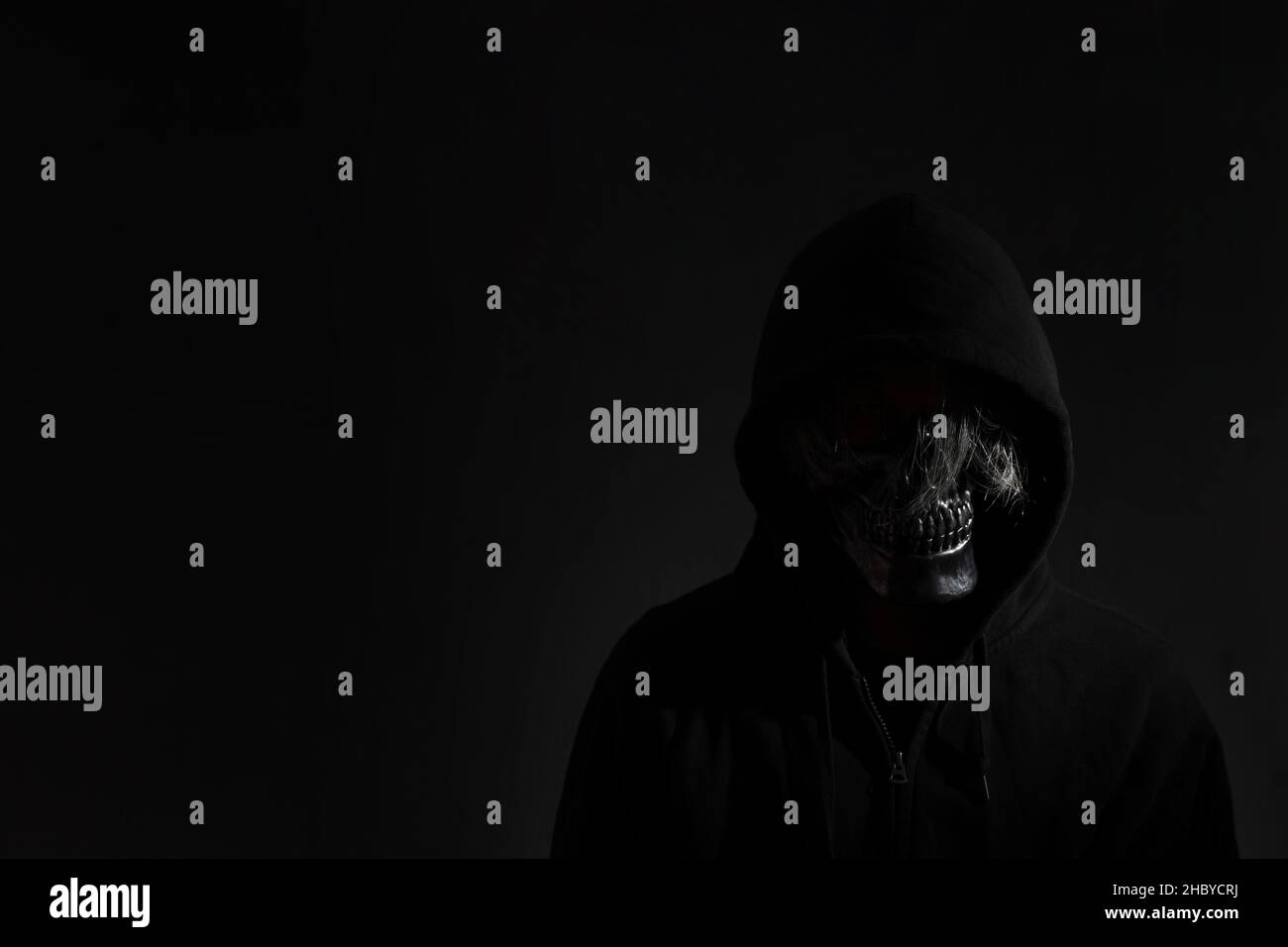 The horror man with skull mask standing in the dark Stock Photo - Alamy