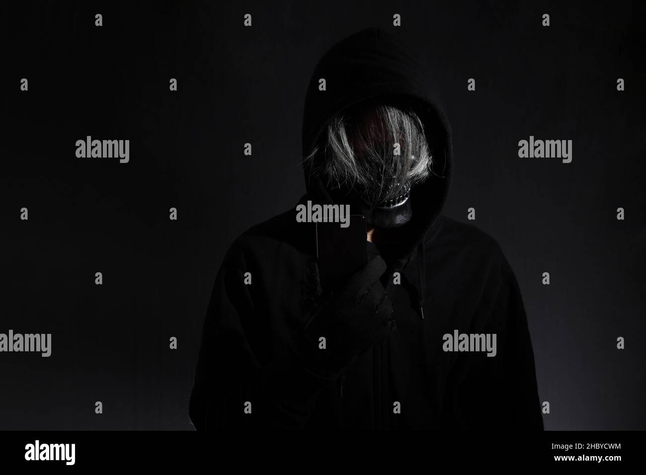 The horror man with skull mask standing in the dark Stock Photo - Alamy