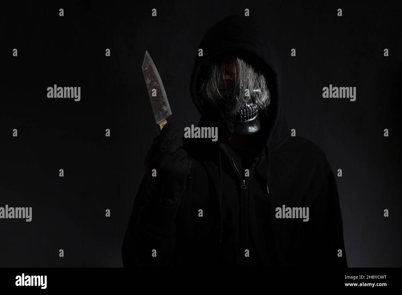 The horror man with skull mask standing in the dark Stock Photo - Alamy
