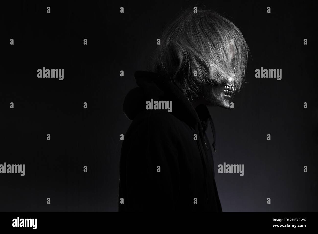 The horror man with skull mask standing in the dark Stock Photo - Alamy