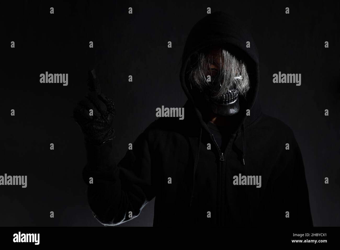 The horror man with skull mask standing in the dark Stock Photo - Alamy