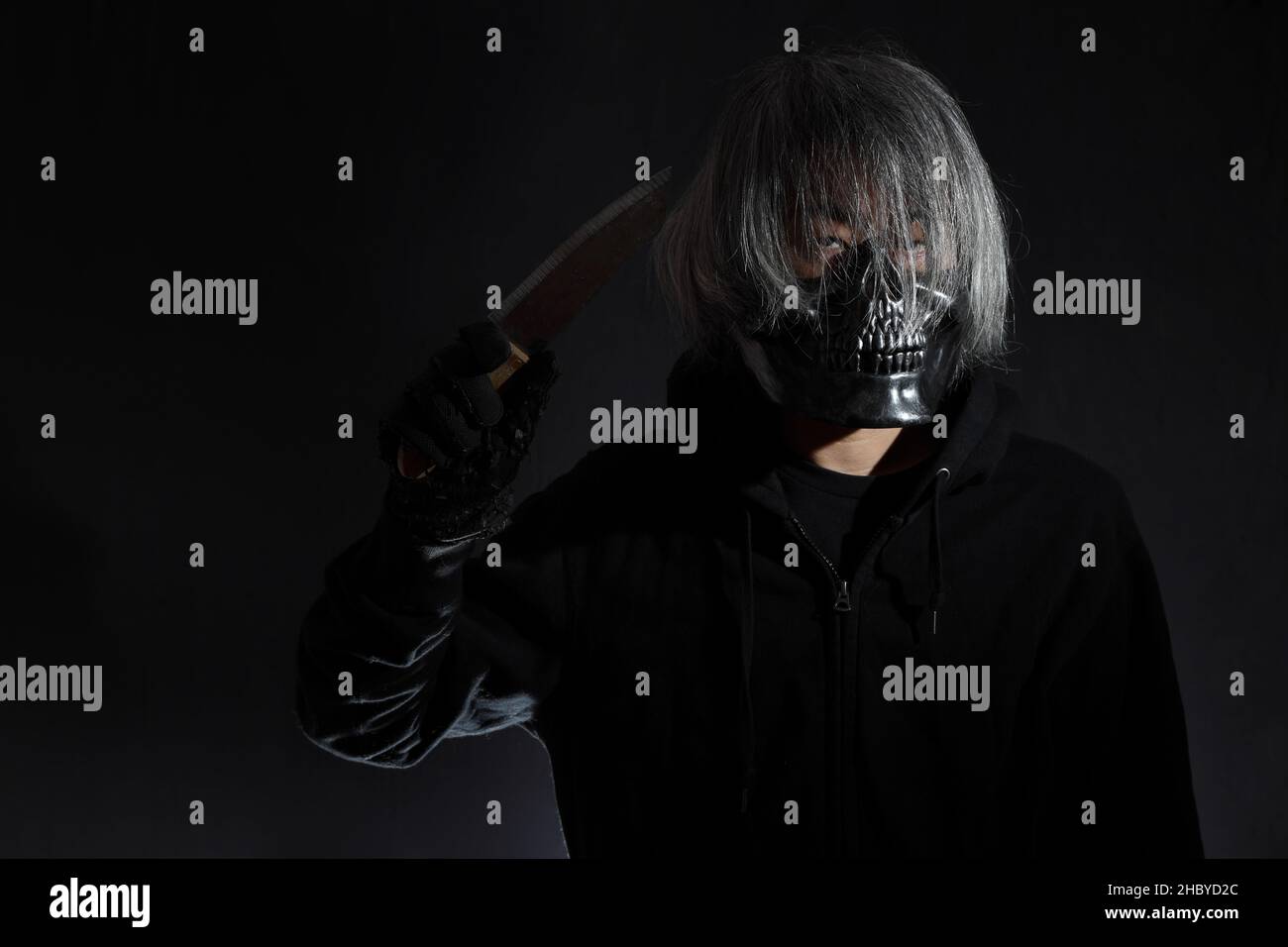 The horror man with skull mask standing in the dark Stock Photo - Alamy