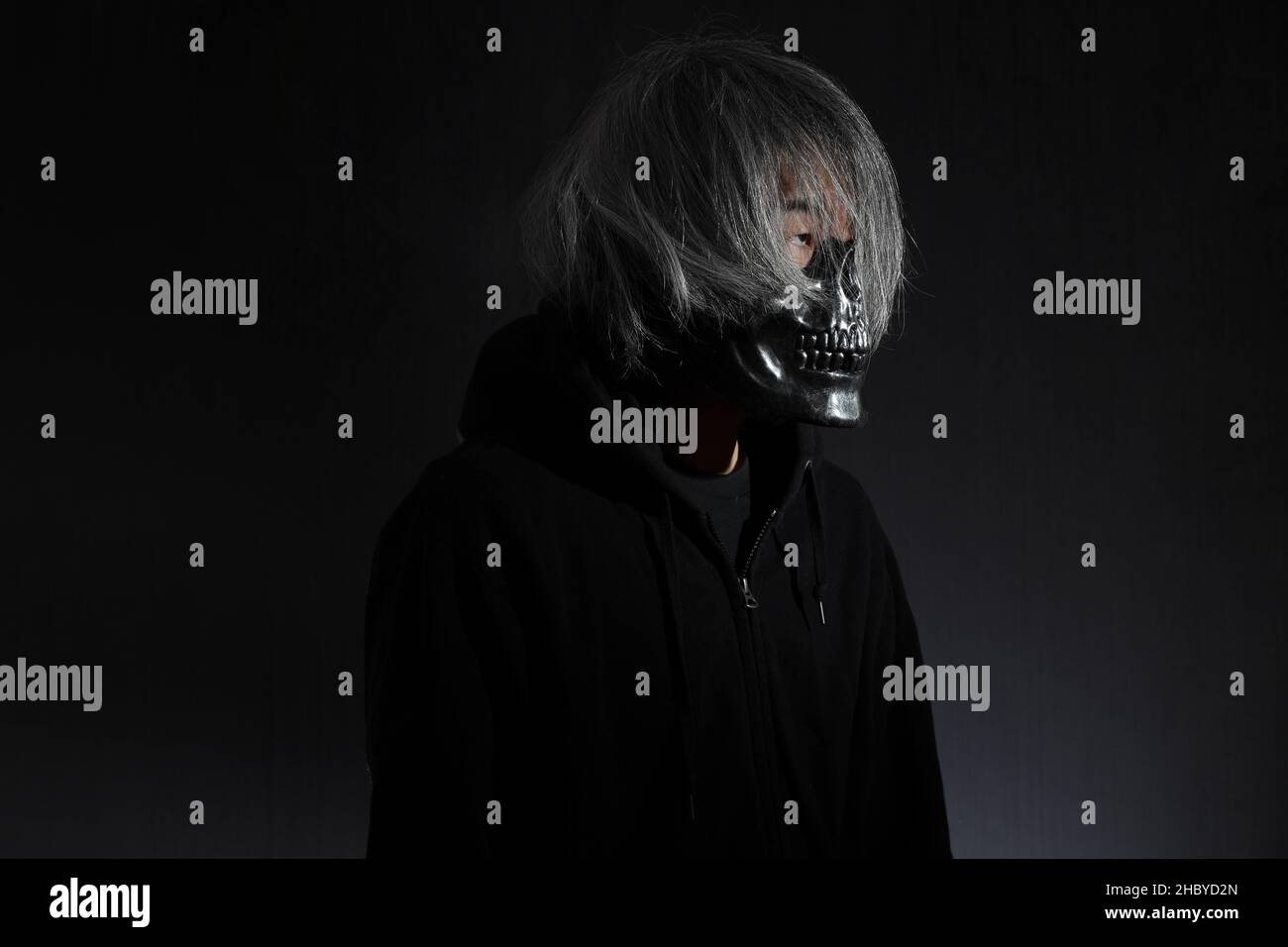 The horror man with skull mask standing in the dark Stock Photo - Alamy