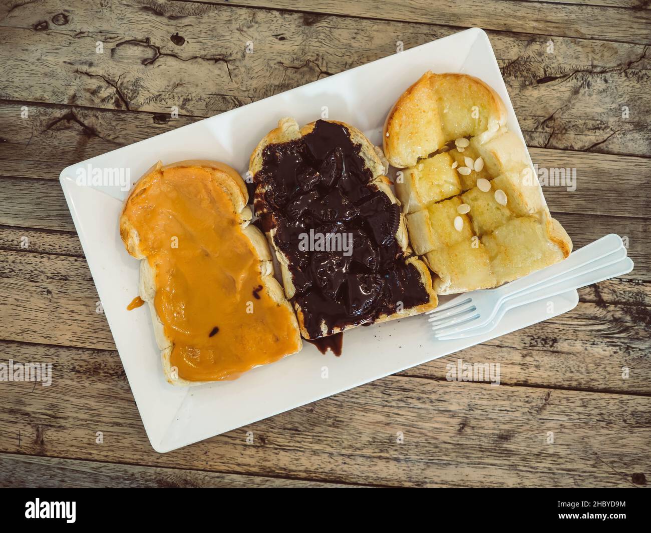 Set of toast breads with different topping of peanut butter, chocolate ...