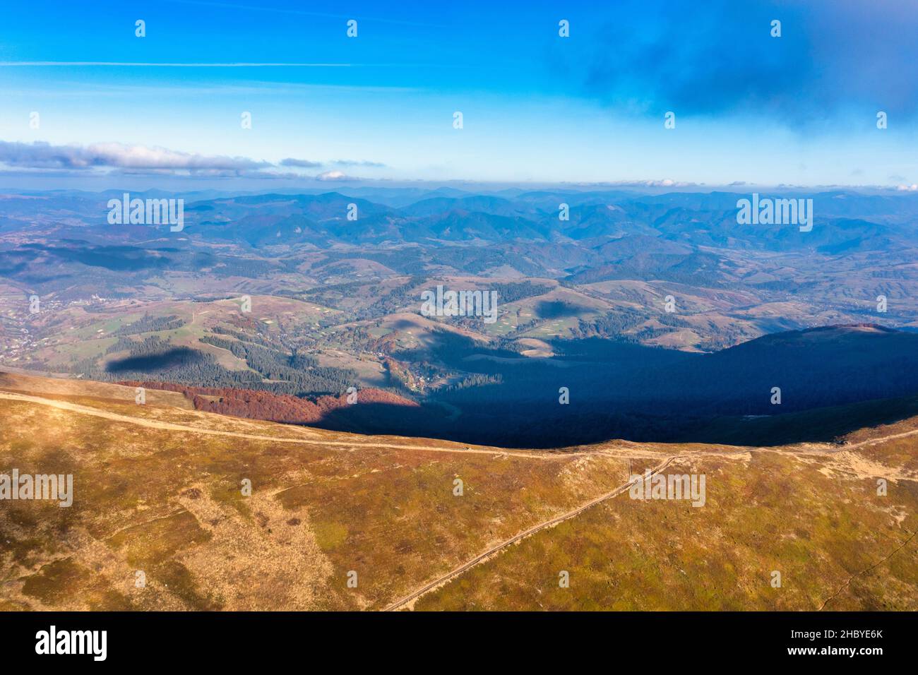 Long narrow pathways running along high mountain ridge under white ...