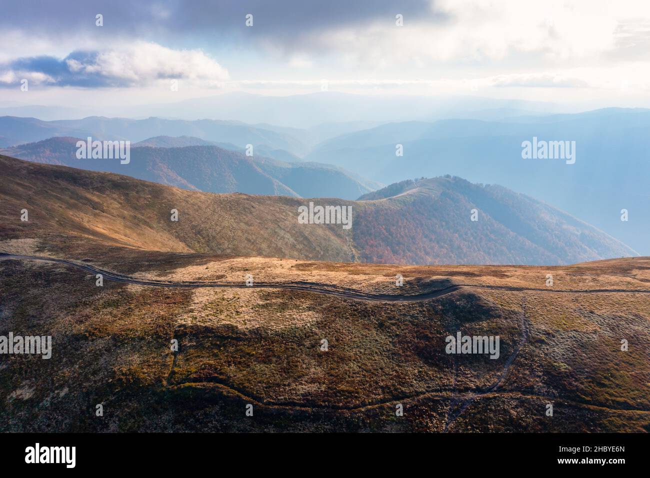 Long narrow pathways running along high mountain ridge under white ...