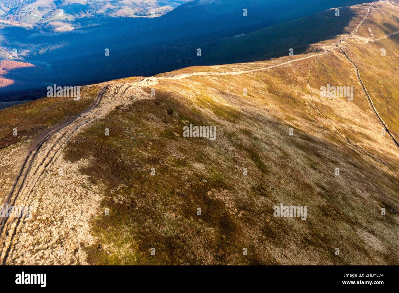 Long narrow pathways running along high mountain ridge under white ...