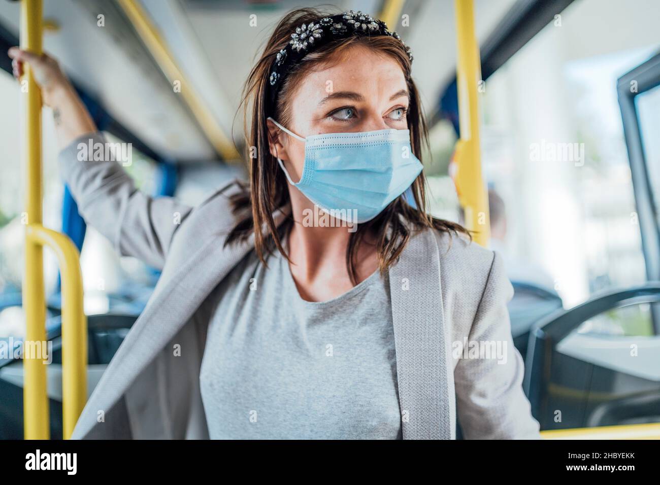 Young woman in protective mask traveling in the bus in Faro, Portugal ...