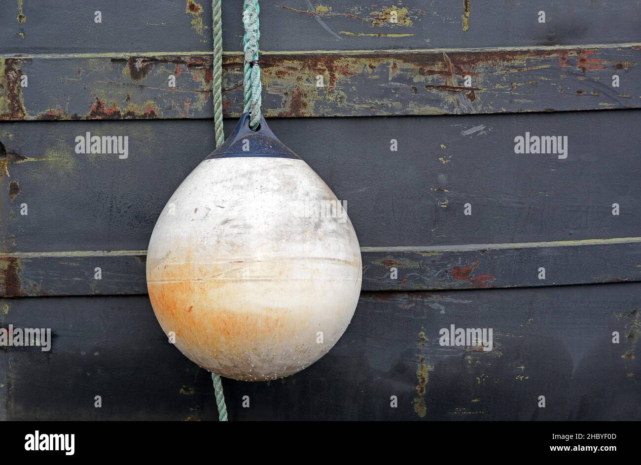White ship's fender in front of old boat wall, Germany Stock Photo - Alamy