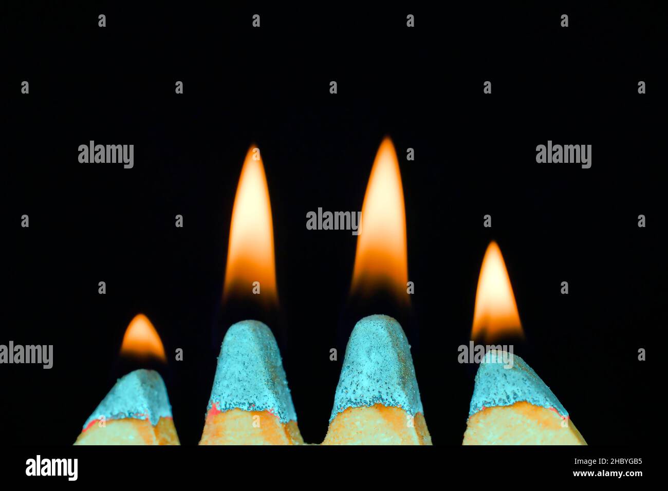 Four flames on match heads, studio photography with black background ...