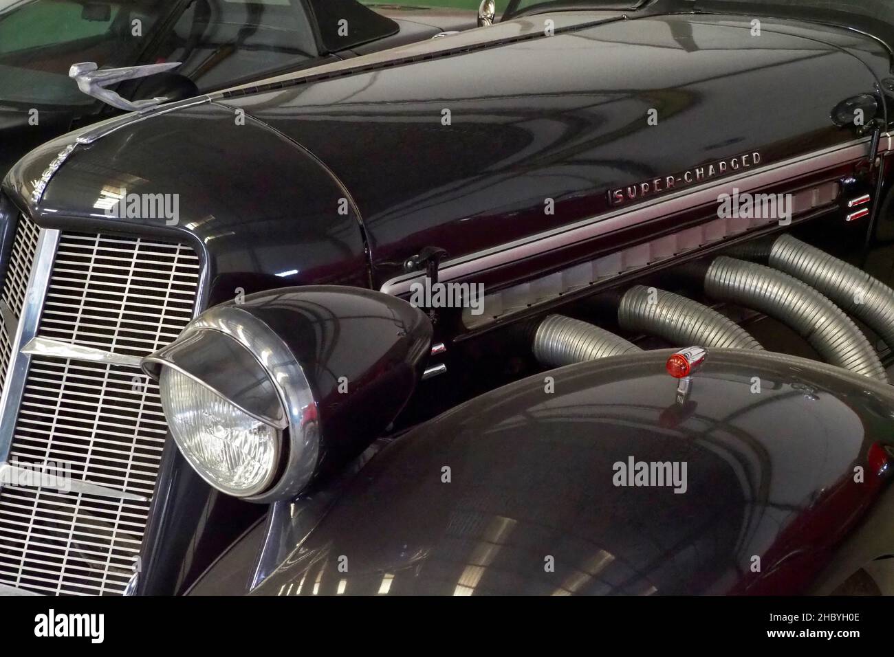 Lamp and radiator grille of a black Auburn Speedster from the side ...