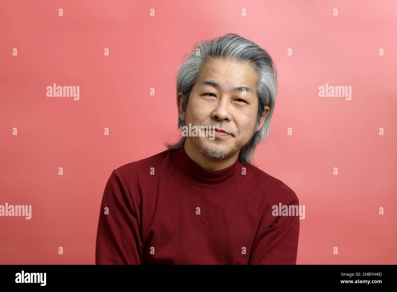 The Asian man portrait with santa claus hat on the pink background ...