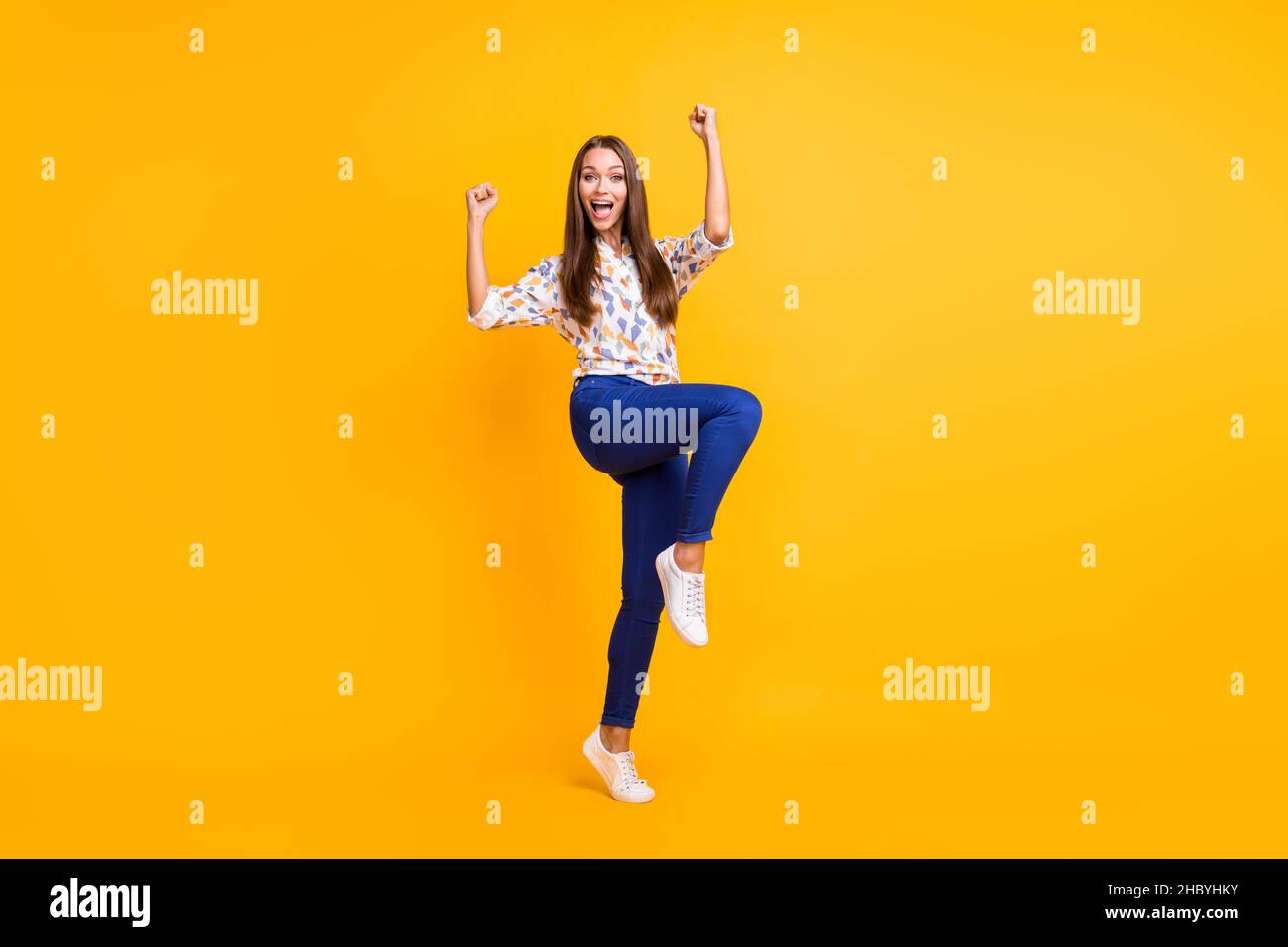 Full length photo portrait of excited woman celebrating with two fists ...