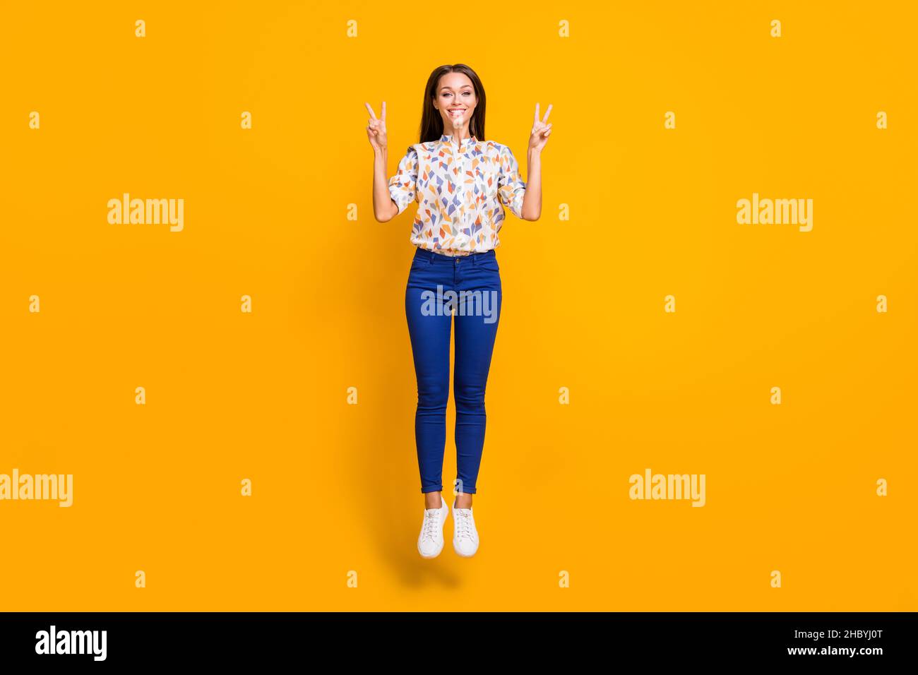 Full length photo portrait of woman showing two v-signs jumping up ...