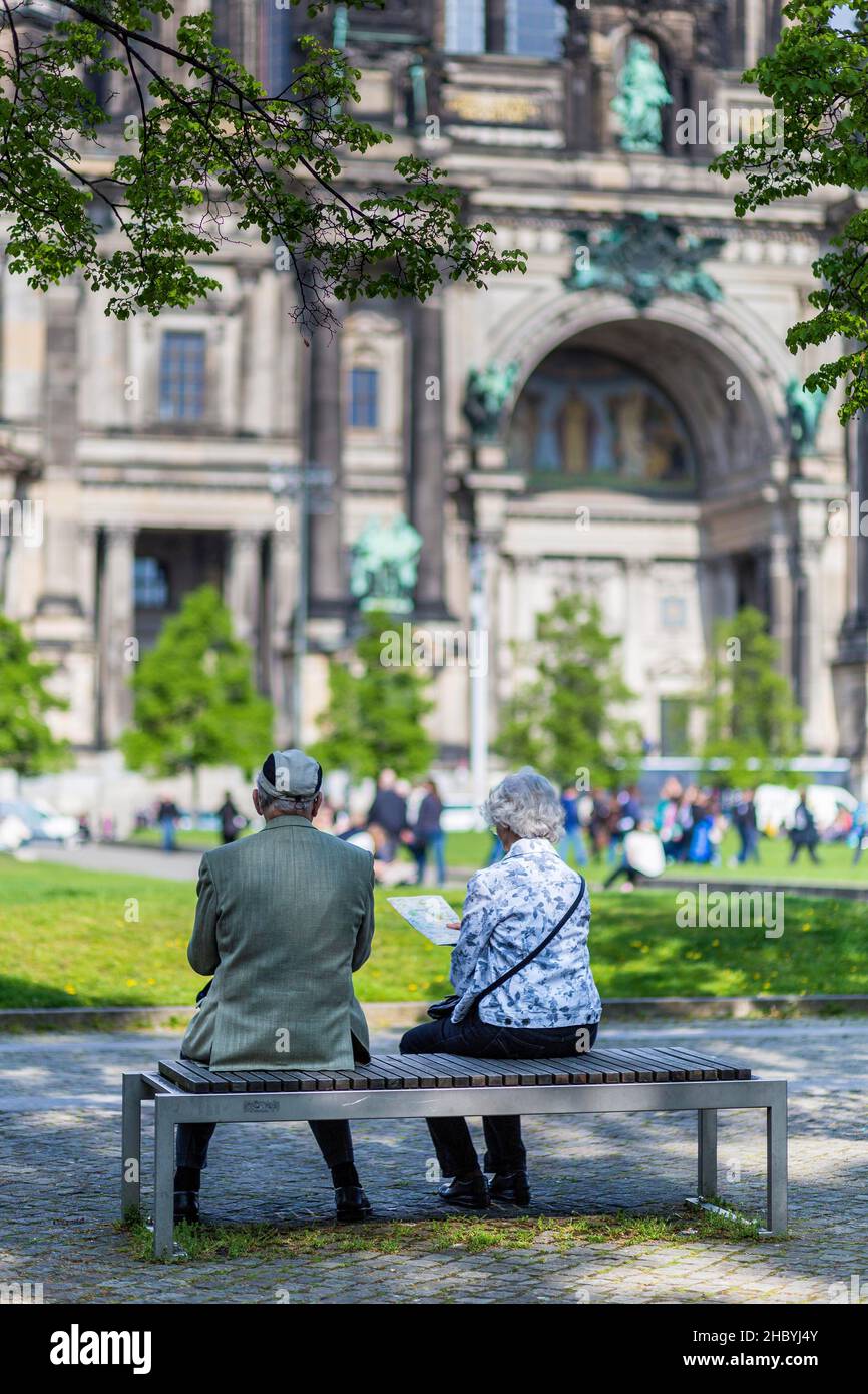 Seniors sitting on a park bench at the Lustgarten, Berlin, Germany ...