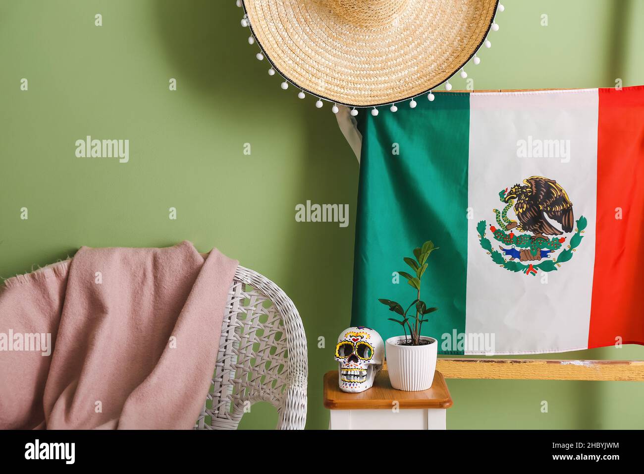 Ladder with Mexican flag near green wall Stock Photo - Alamy