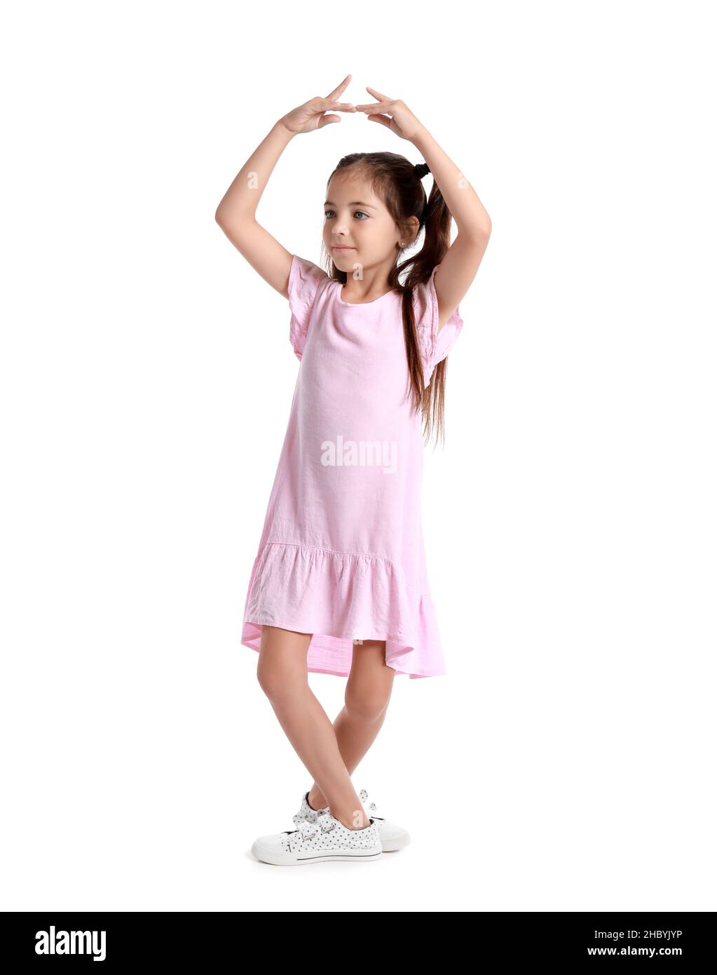 Adorable little girl in pink dress dancing on white background Stock ...