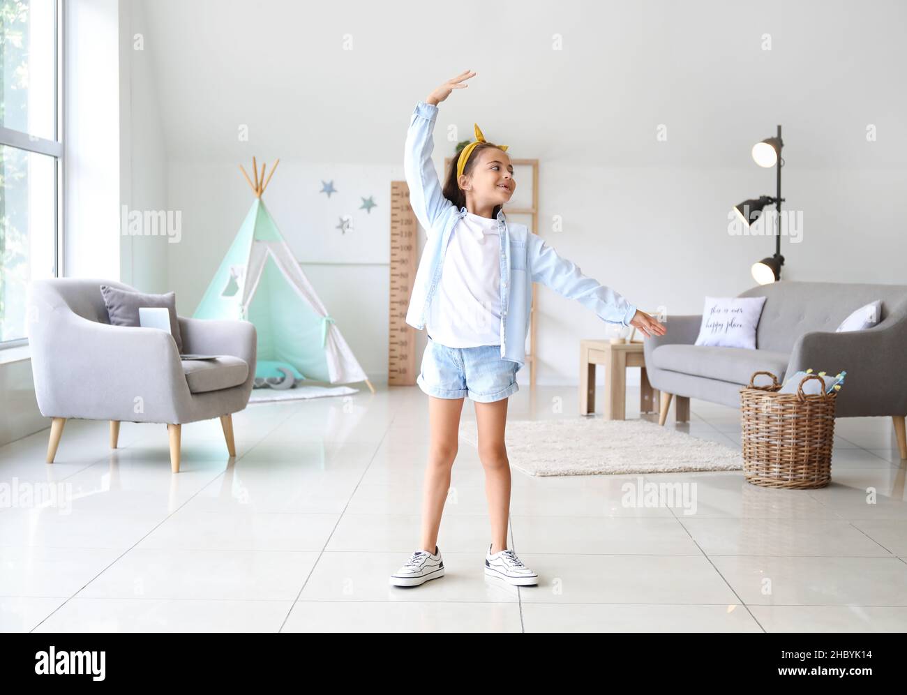 Adorable little girl dancing at home Stock Photo - Alamy