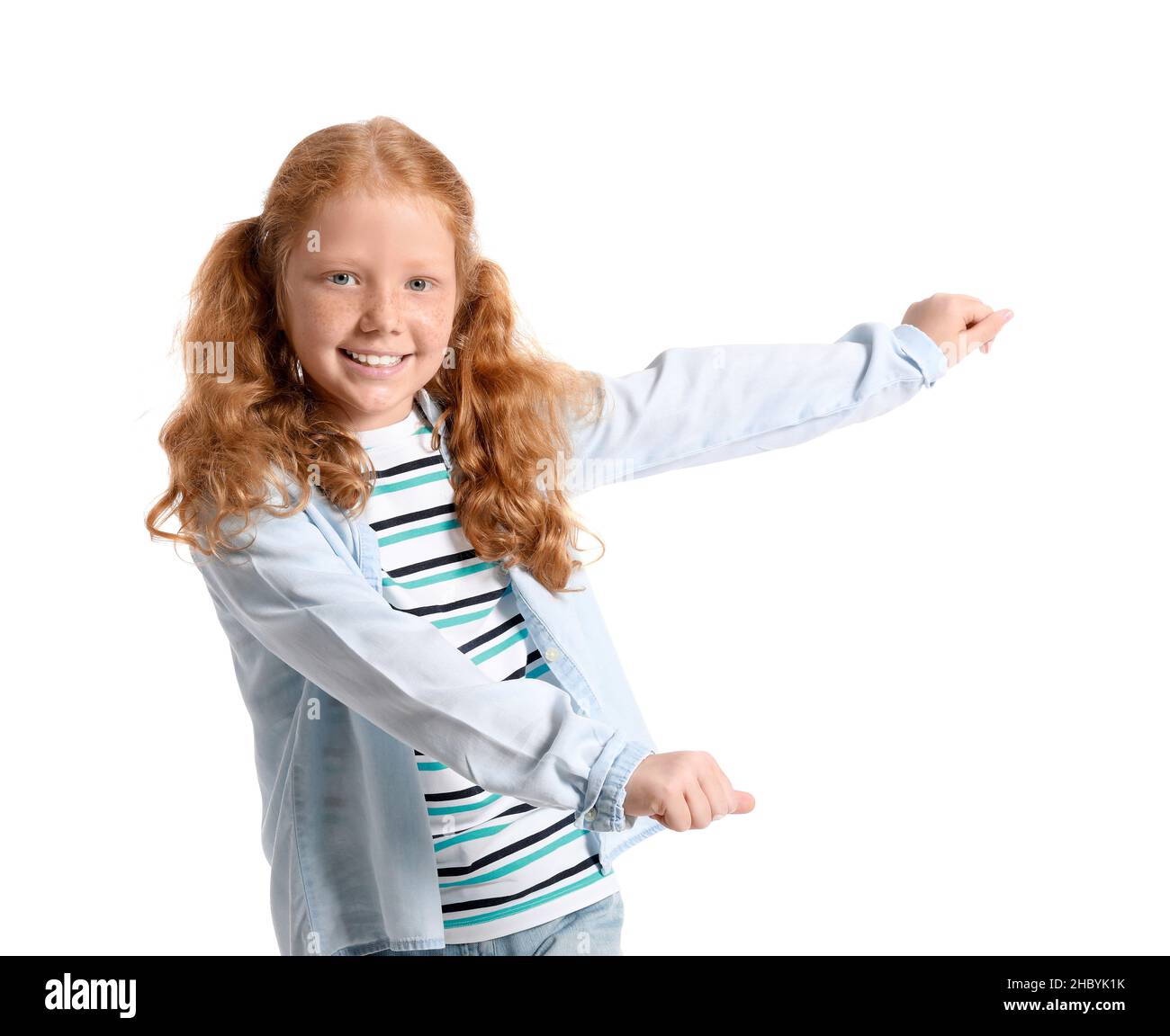Little redhead girl with ponytails dancing on white background Stock ...