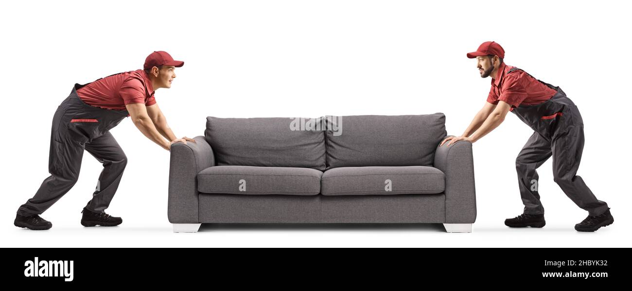 Two male workers moving a grey sofa isolated on white background Stock ...
