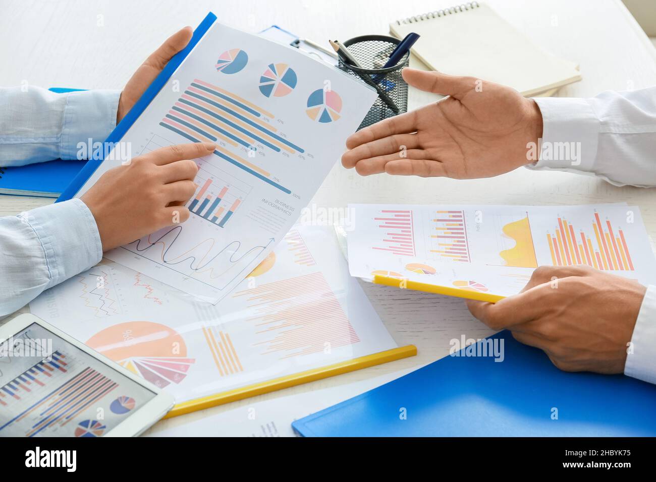 Businessman and his secretary with documents at table in office ...
