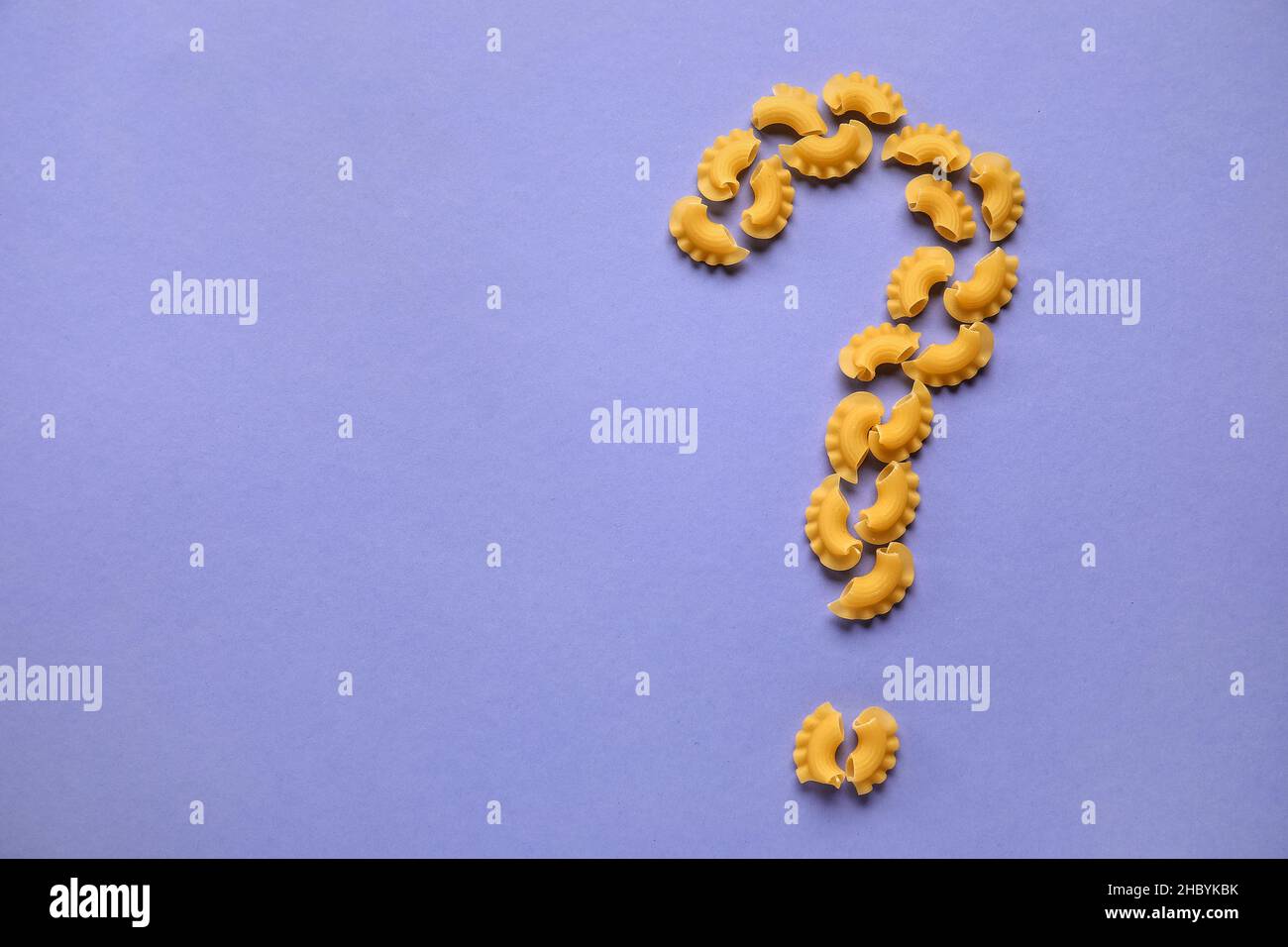 Question mark made of dry pasta on purple background Stock Photo - Alamy