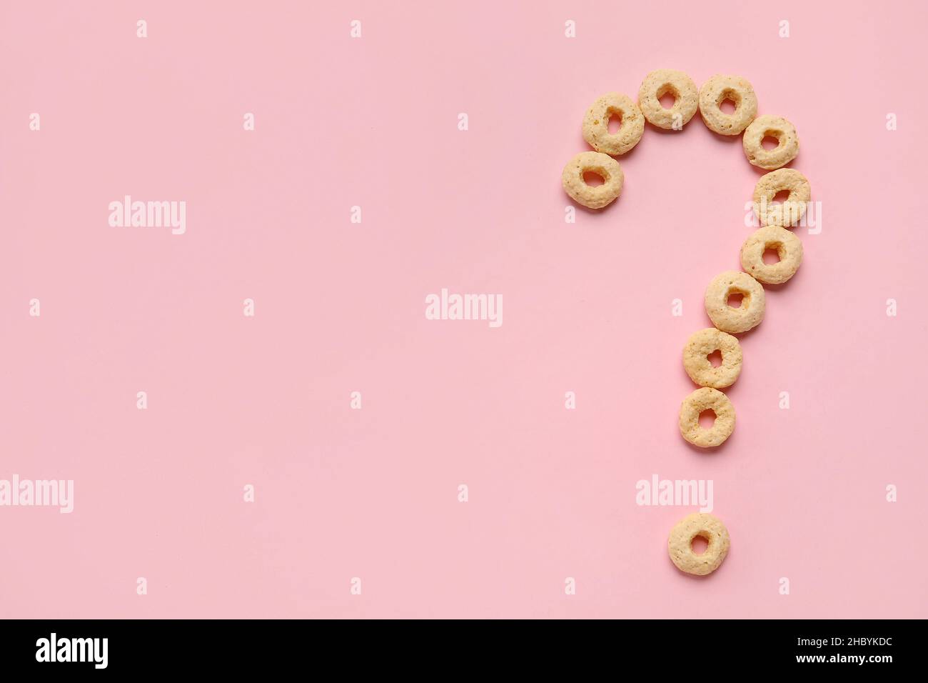 Question mark made of cornflakes on pink background Stock Photo - Alamy