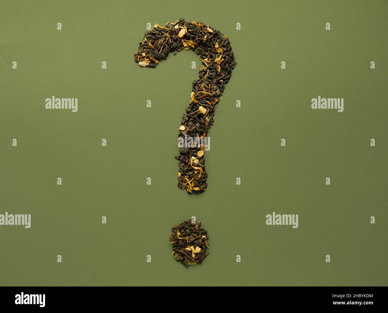 Question mark made of dry tea on green background Stock Photo - Alamy