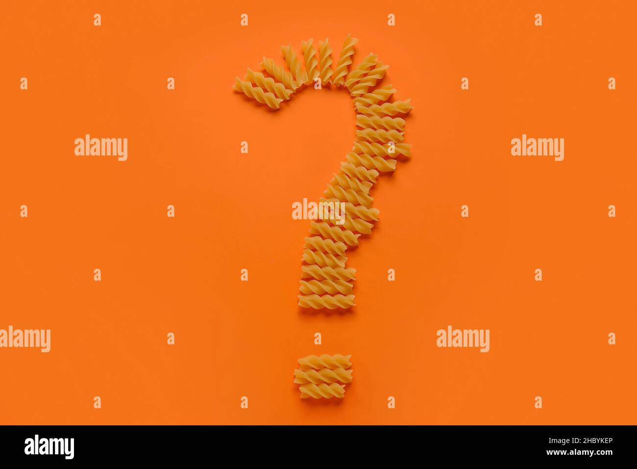 Question mark made of dry pasta on red background Stock Photo - Alamy