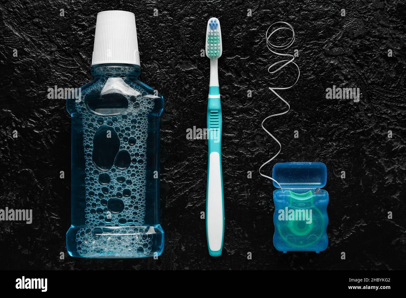 Dental floss with tooth brush and rinse on dark background Stock Photo ...