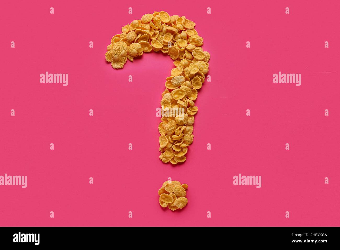 Question mark made of cornflakes on pink background Stock Photo - Alamy