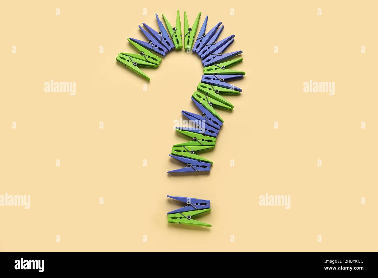 Question mark made of clothespins on beige background Stock Photo - Alamy