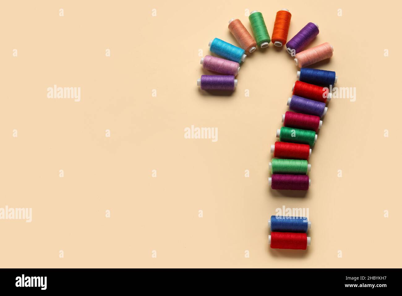 Question mark made of sewing threads on beige background Stock Photo ...