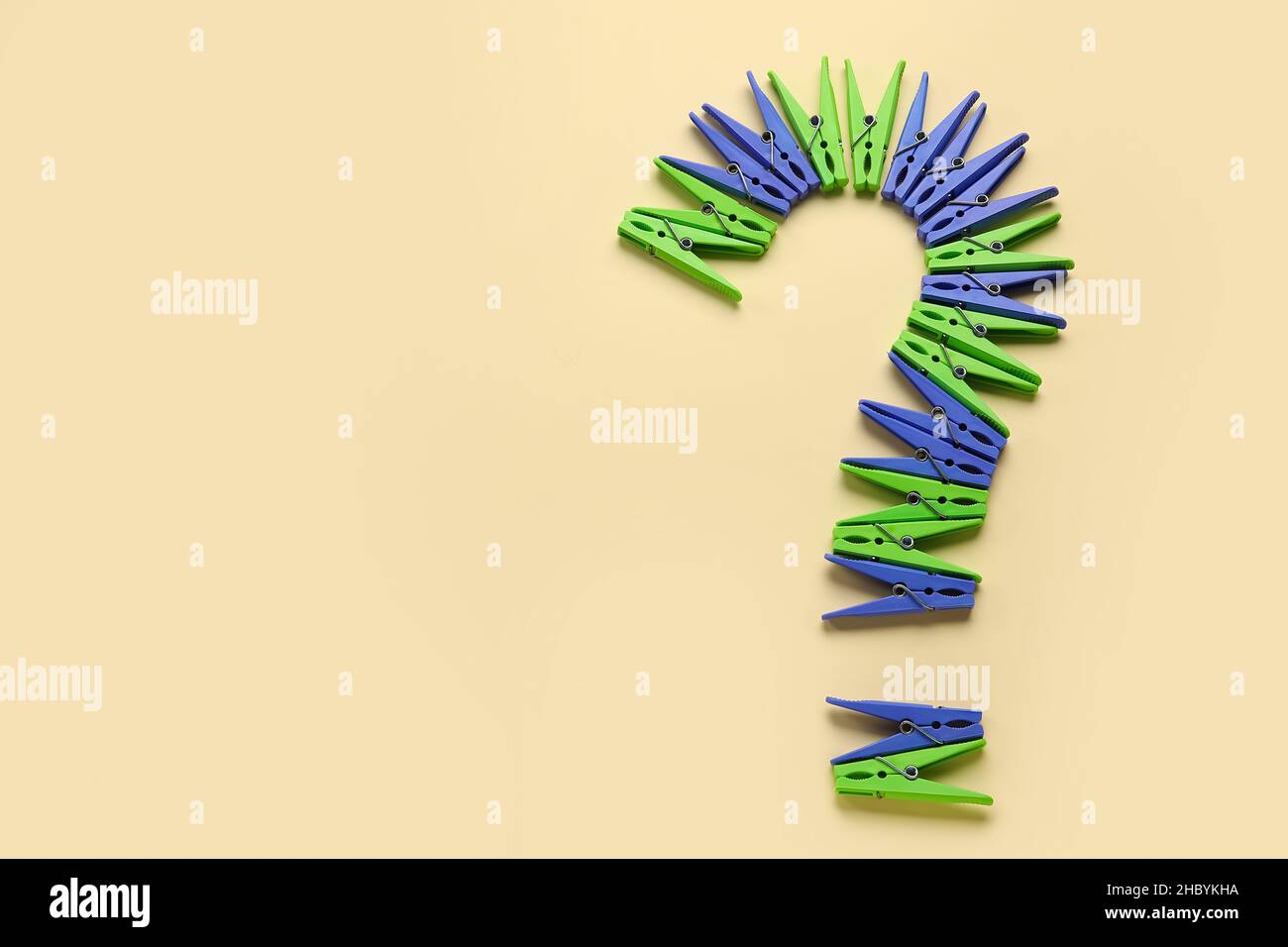 Question mark made of clothespins on beige background Stock Photo - Alamy