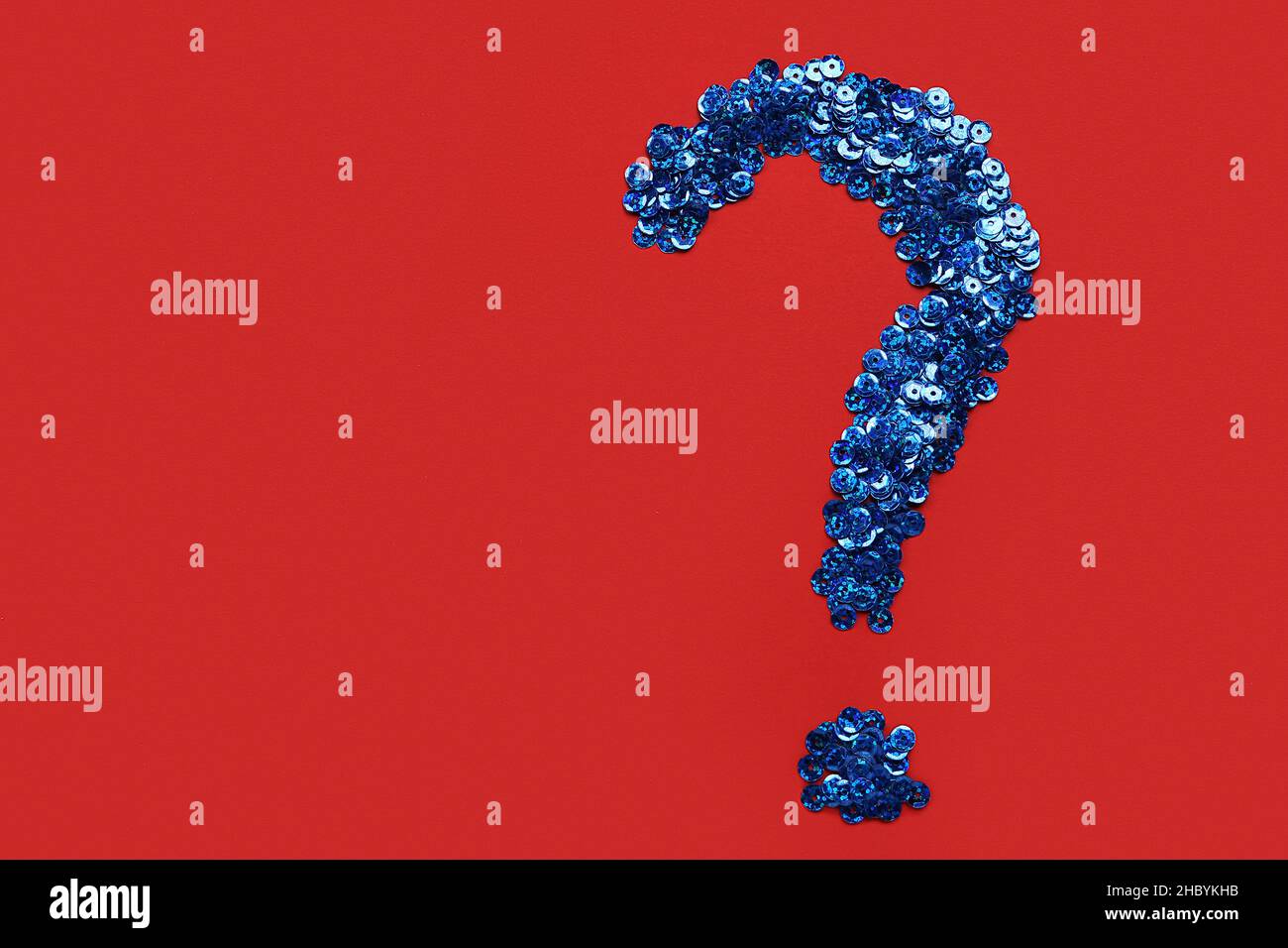 Question mark made of blue sequins on red background Stock Photo - Alamy