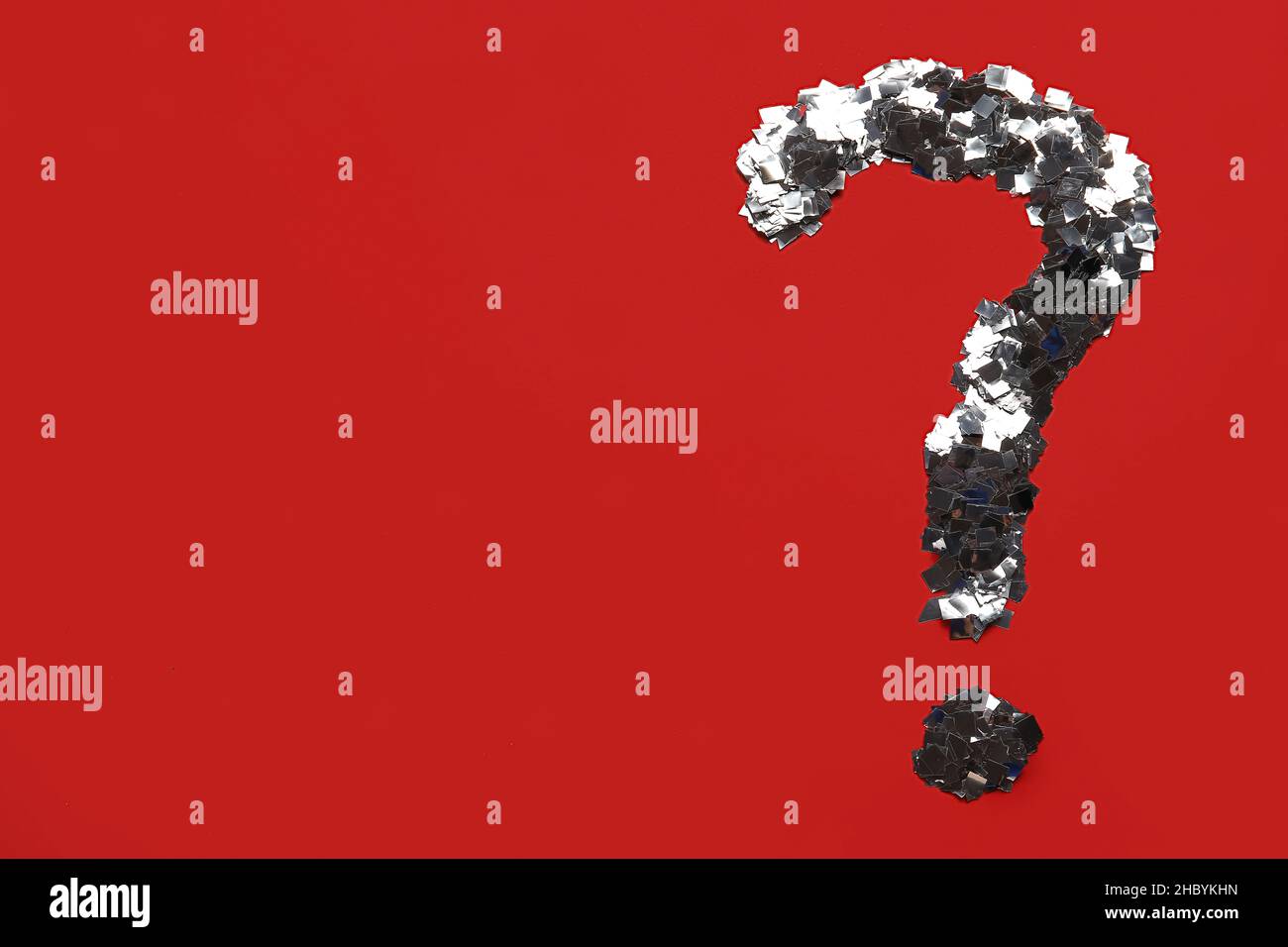 Question mark made of silver confetti on red background Stock Photo - Alamy
