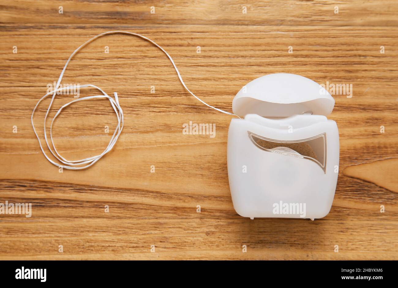 Dental floss on wooden background Stock Photo - Alamy