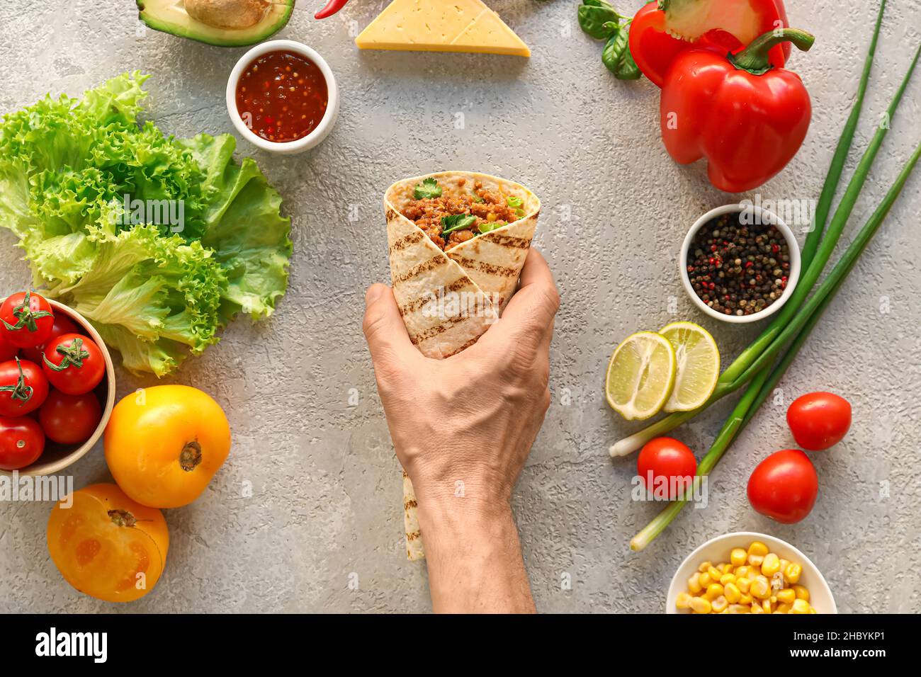 Hand holding mexican street food burrito hi-res stock photography and ...