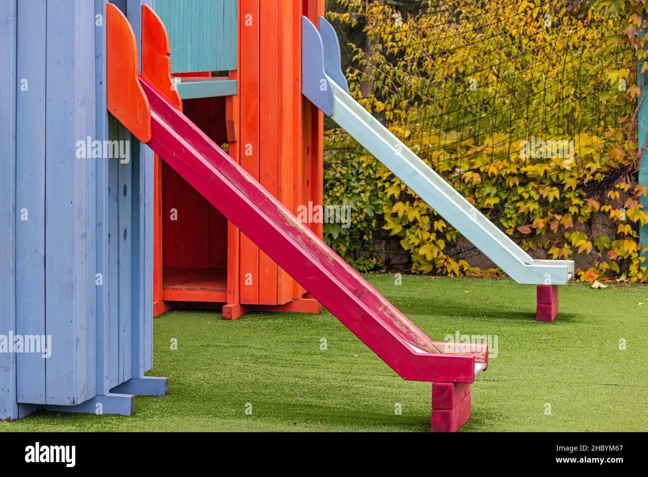 Red Slide in Wooden Castle Playground for Kids Stock Photo - Alamy