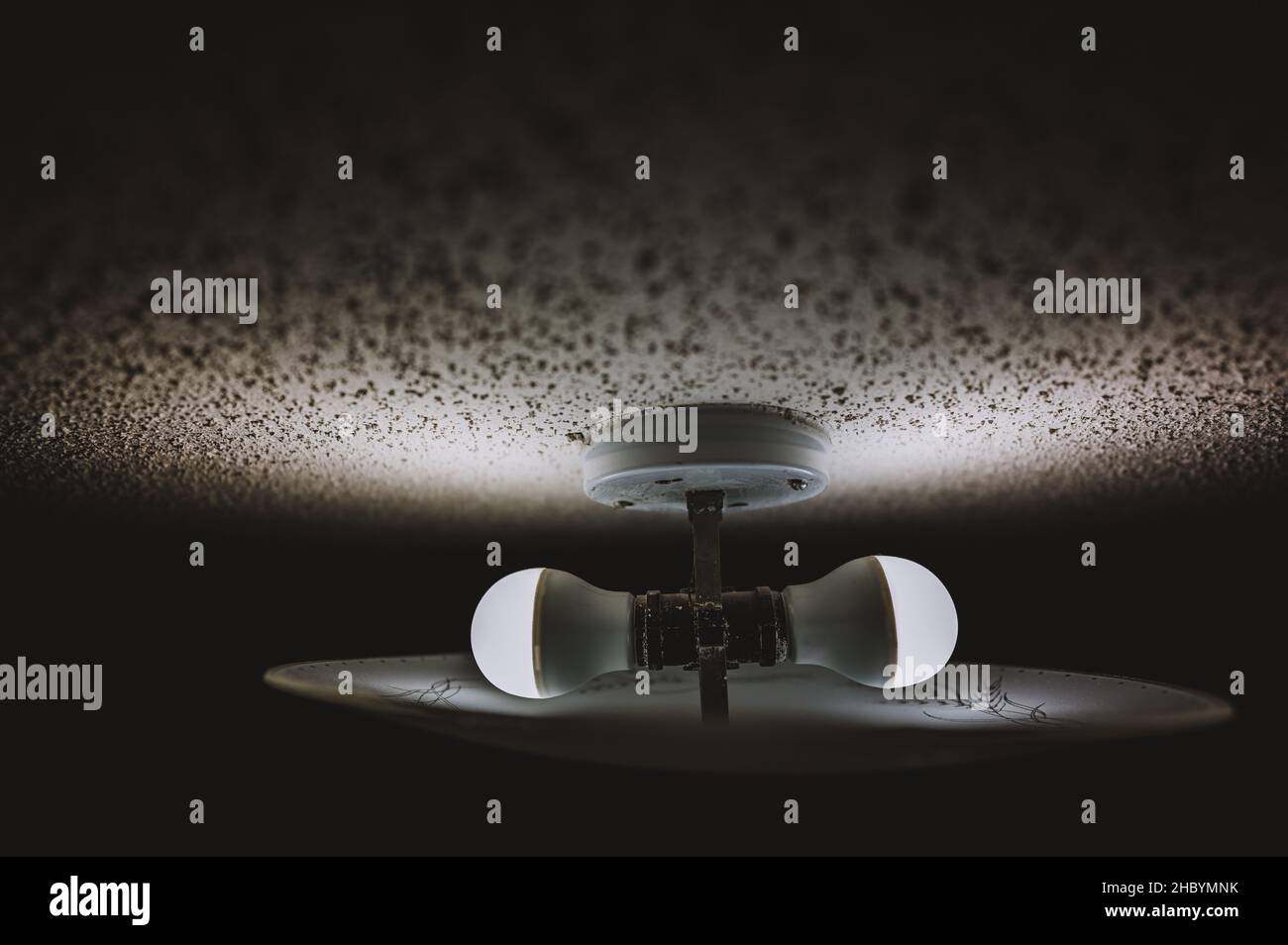 popcorn textured ceiling with LED bulb light fixture and glass cover ...