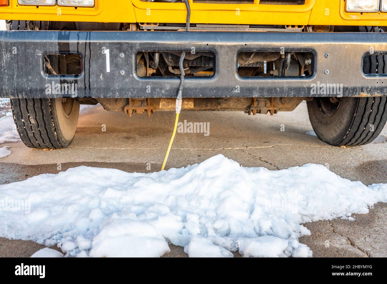 Power cord plugged into a vehicle engine heating block on a bus in a ...
