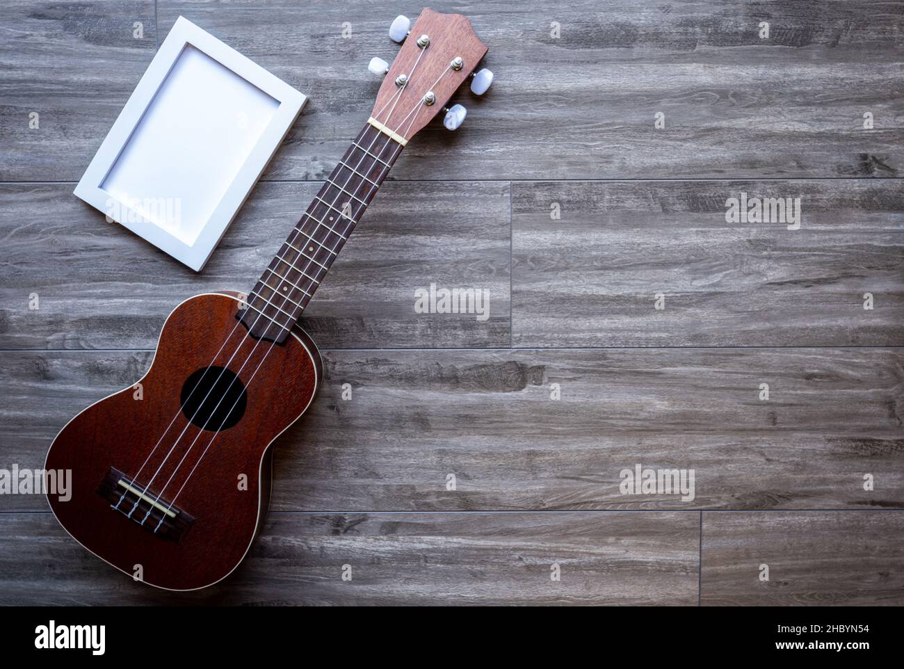 Ukulele guitar on gray wooden desk table for musician business ...
