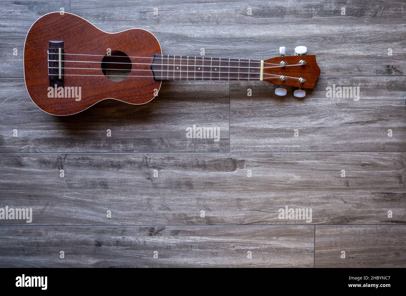 Ukulele guitar on gray wooden desk table for musician business ...