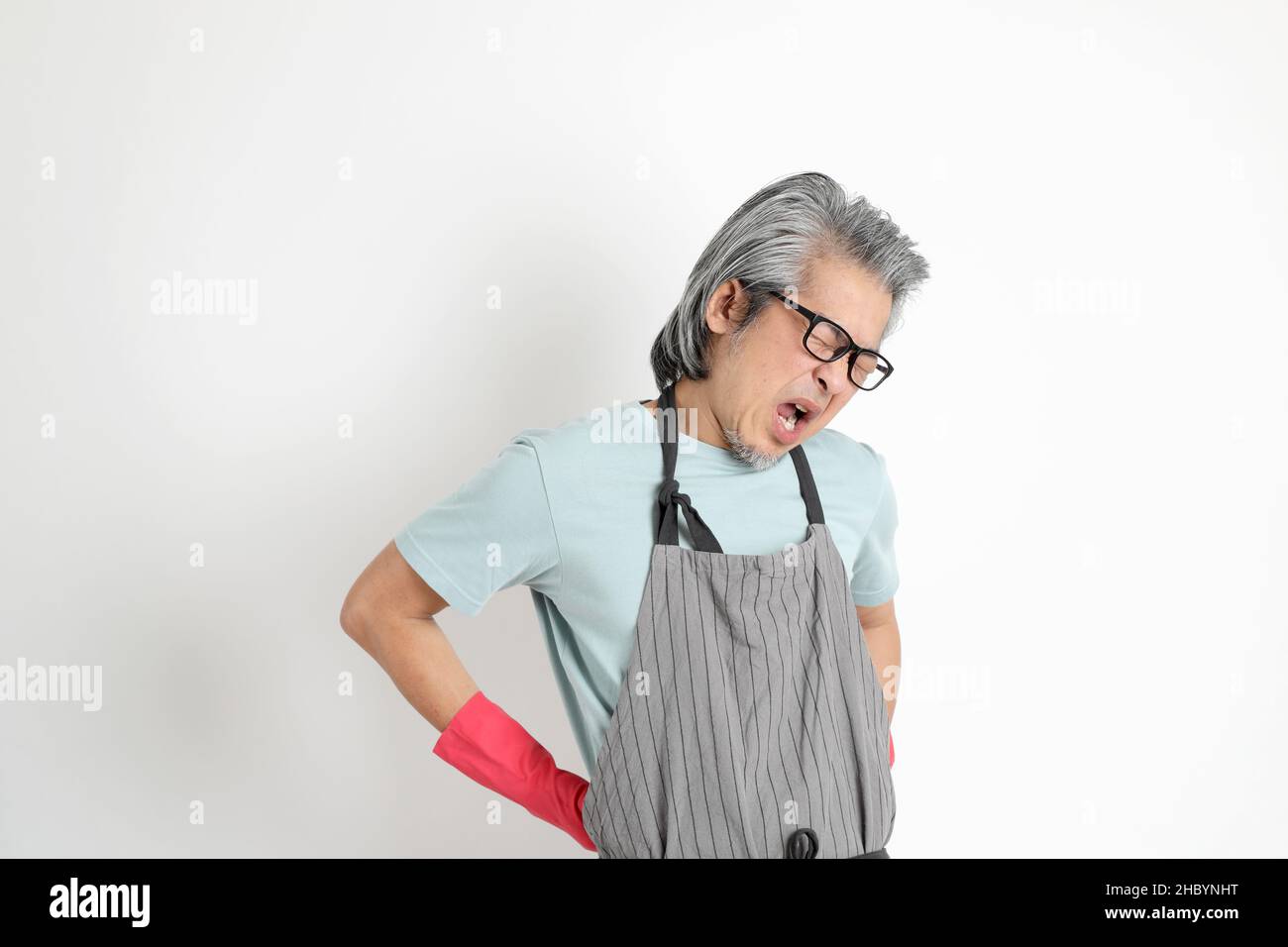 The senior Asian housekeeper standing on the white background Stock ...