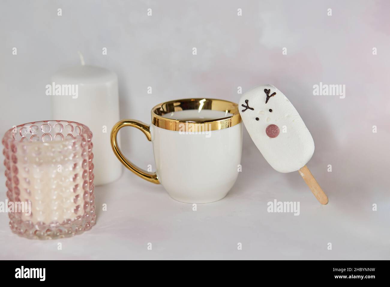 Cozy afternoon tea with white cup, cute marshmallow deer, gingerbread ...